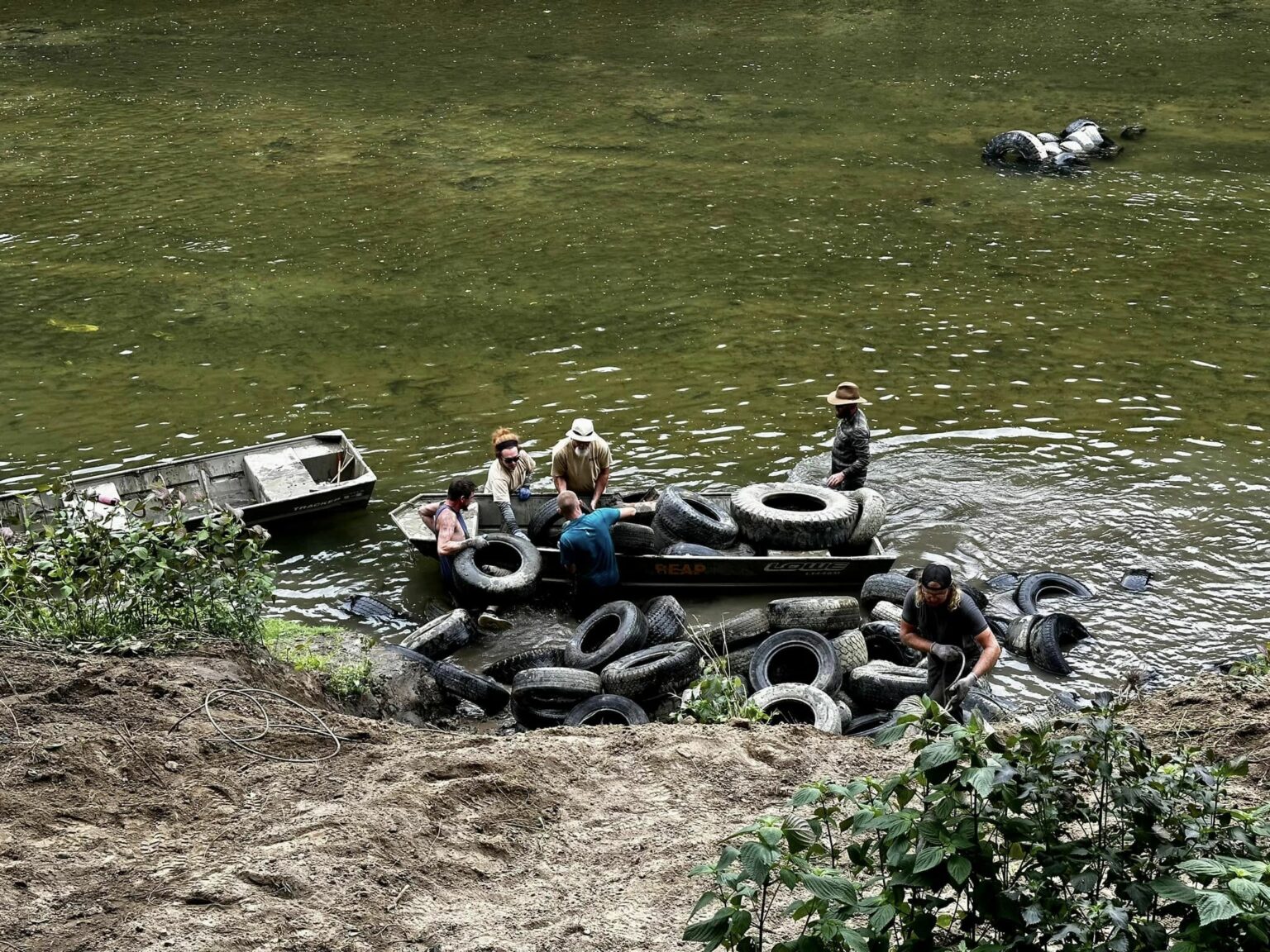Volunteers continue to pull hundreds of tires from the Tug Fork River ...